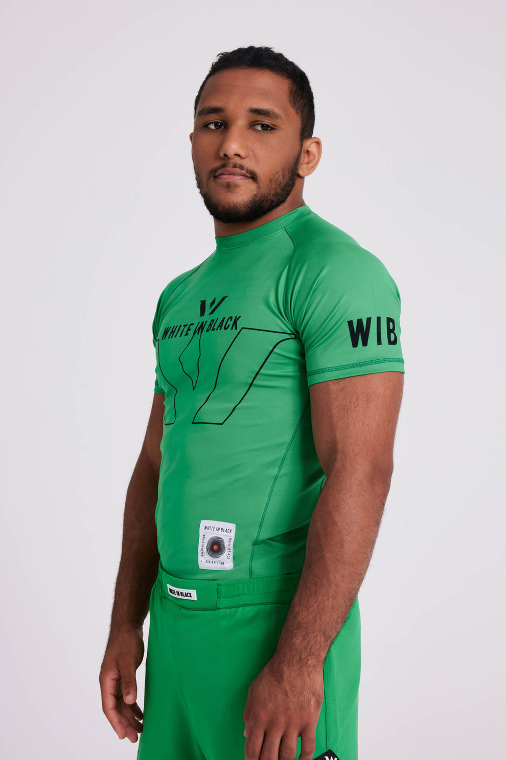 COLL1: Green Rash Guard – White in Black